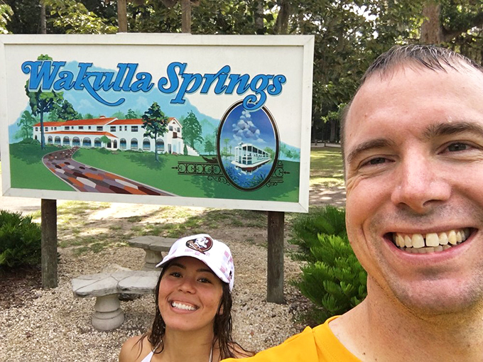 Vacation victory lap! Happy visitors capture their Wakulla Springs moment, where memories are made against a backdrop of natural Florida splendor.