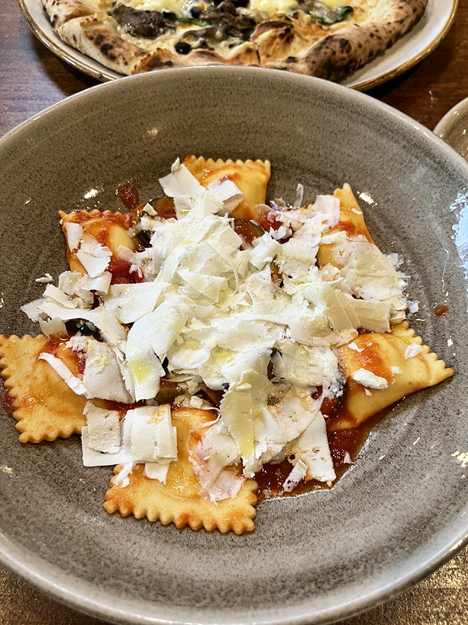 These ravioli, blanketed with shaved cheese, aren't just pasta pockets&mdash;they're little envelopes delivering good news to your taste buds.