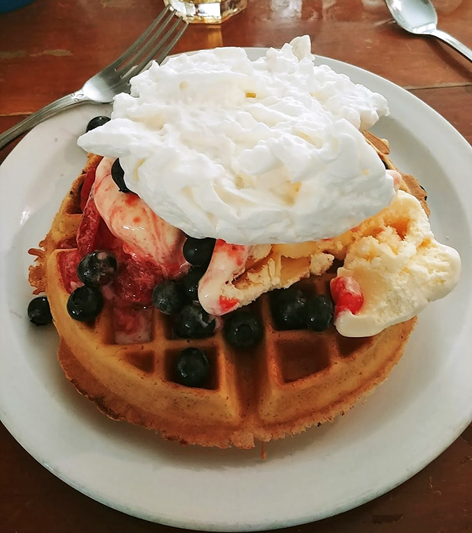 A waffle that's dressed for success with berries, cream, and enough toppings to make you forget you're technically eating breakfast.