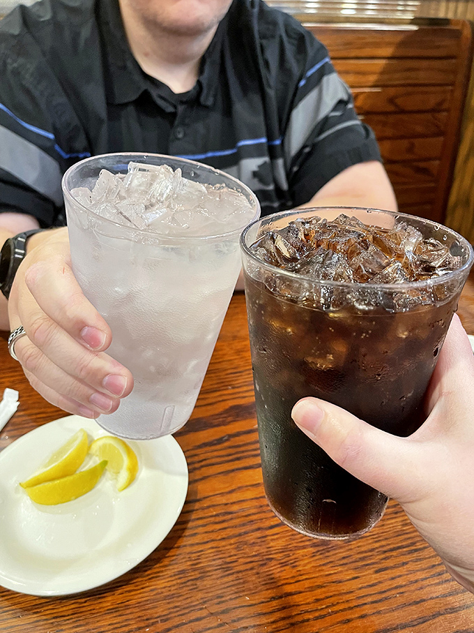 Ice-cold drinks with lemon wedges standing by – because proper BBQ demands proper hydration between flavor explosions.