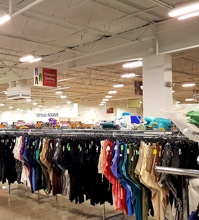 Rainbow rows of women's clothing stretch toward fitting rooms, organized by size and type&mdash;no digging through chaotic piles like thrift stores of yesteryear.