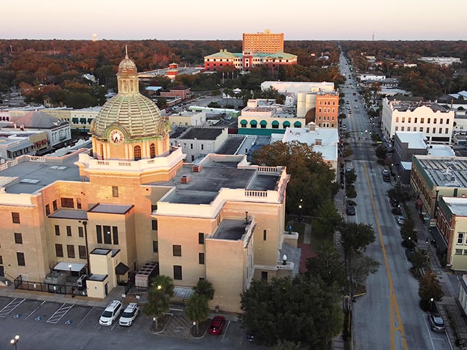 DeLand's golden dome catches sunset's glow like a historical lighthouse, beckoning antique hunters through streets lined with potential treasures.
