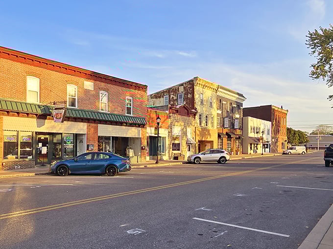 Sunshine bathes Delmar's main street in golden light, highlighting the warm brick facades that have witnessed decades of small-town life.