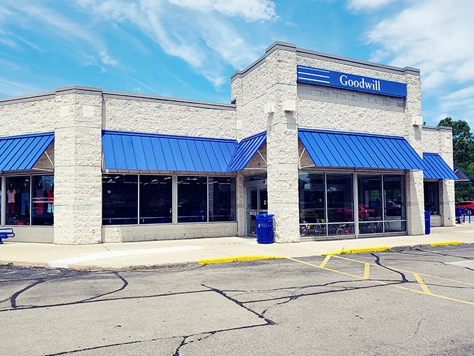 Goodwill's crisp stone exterior and blue awnings offer a hint of the organized treasure hunt waiting inside.