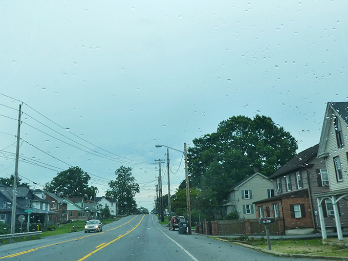 A rainy day view of Gordonville's residential street showcases the mix of traditional and modern homes in this Amish community.