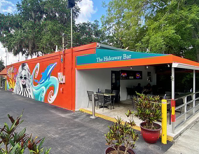 The Hideaway's orange walls and vibrant murals turn a simple bar into Orlando's most colorful escape from theme park madness.
