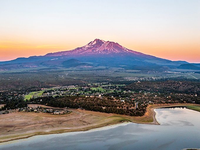 Mount Shasta's snow-capped peak dominates the landscape at sunset. The mountain seems to glow with its own inner light.