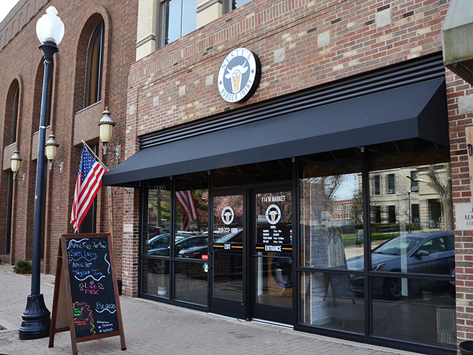 Nesty's understated brick exterior with classic navy awning whispers rather than shouts about the burger magic happening inside. Let the food do the talking!