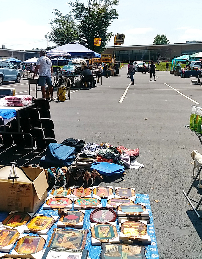 Phila Flea Markets' outdoor setup with shoppers browsing tables in a parking lot. Urban treasure hunting at its finest!
