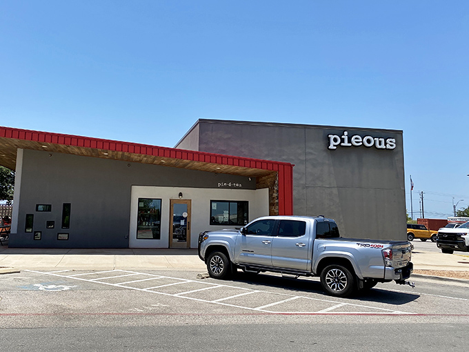 Pieous: Modern industrial meets pizza perfection in this striking building. The red and gray exterior hints at the fire and smoke magic happening inside!