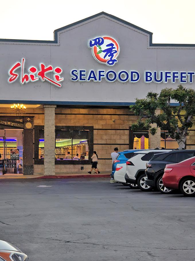 The sign glows like a beacon for buffet aficionados. Where seafood dreams come true after sunset!