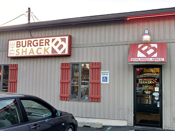 The Burger Shack's modest exterior with red shutters is like a storybook cottage that happens to serve incredible burgers.