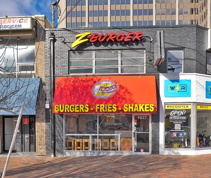 Z-Burger's bold orange signage pops against the gray brick exterior. Urban burger artistry that demands your attention.