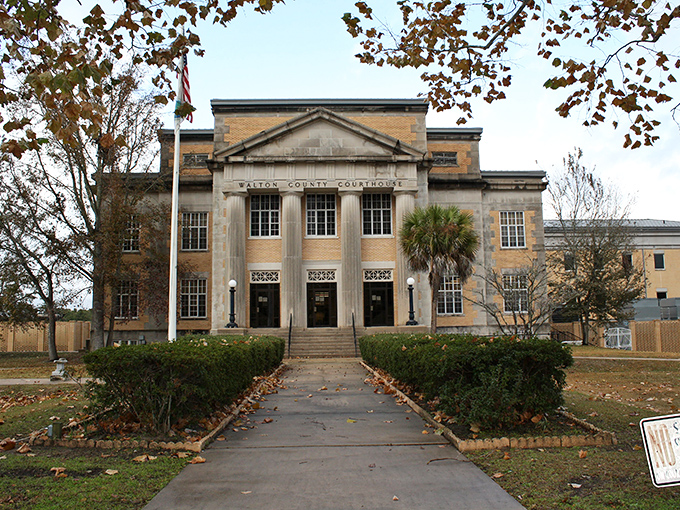Classical architecture stands proudly against autumn leaves, proving some things never go out of style gracefully.