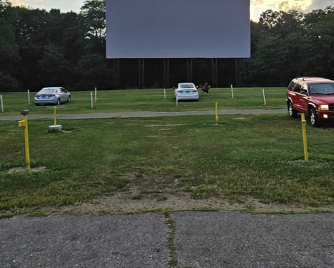 The projector casts its magic as twilight fades, transforming an ordinary field into a cathedral of storytelling.
