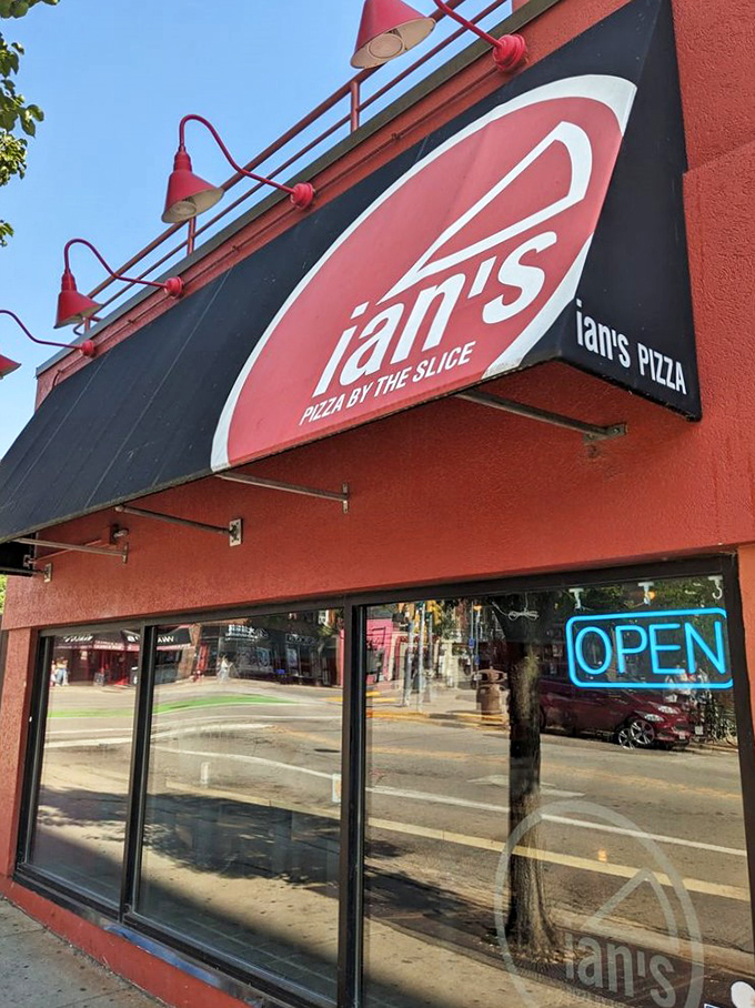 Ian's vibrant red exterior matches the energy inside. Where else can you find mac and cheese pizza that actually works?