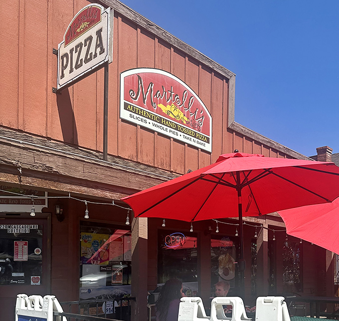 Those cheerful umbrellas promise outdoor dining bliss where mountain air makes every bite taste like vacation.