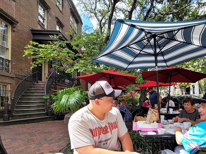 Striped umbrellas and brick courtyard &ndash; where strangers become friends over passed platters of fried chicken perfection.