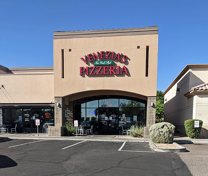 The clean lines of Venezia's daytime facade hide the pizza paradise within, where thin crust reigns supreme in the Arizona heat.