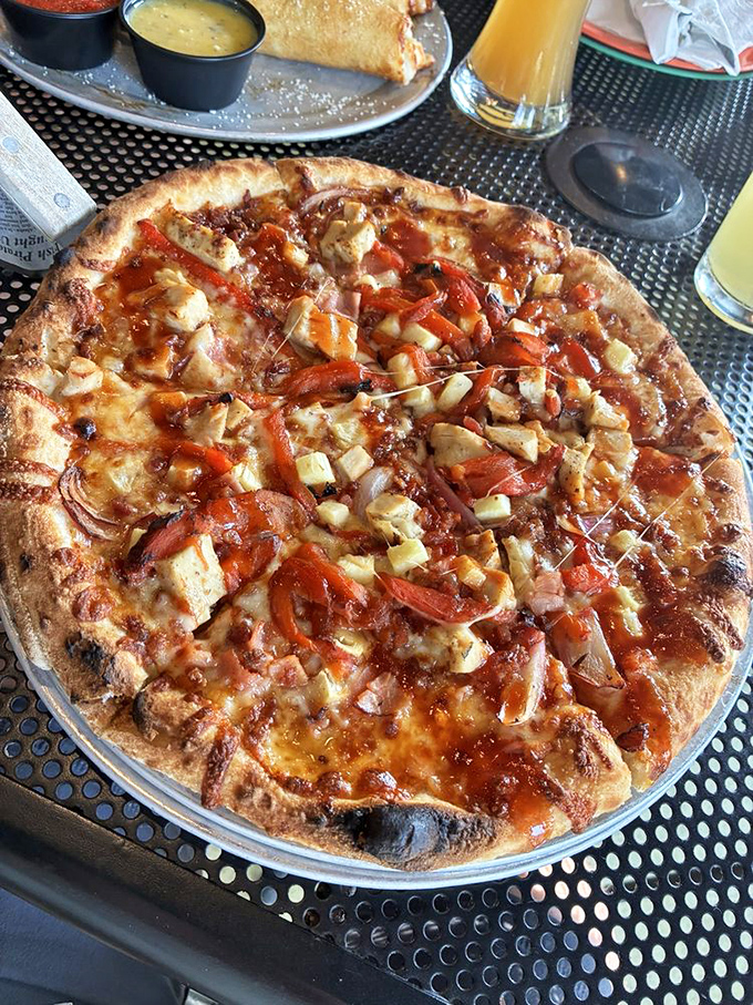 The Aloha Pizza brings the party with chunks of chicken, red peppers, and a sauce that makes your taste buds feel like they're on vacation.