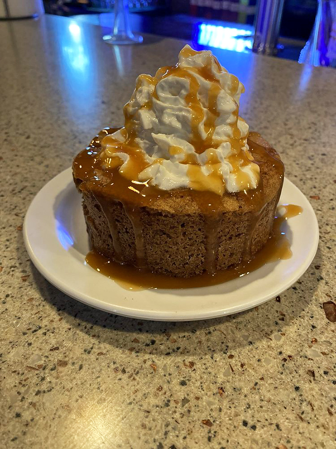 Not just dessert, but the final act in a barbecue symphony. This apple cake with whipped cream and caramel is the standing ovation.