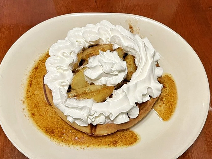 A Belgian waffle crowned with whipped cream and apples that makes ordinary breakfast seem like a tragic missed opportunity.