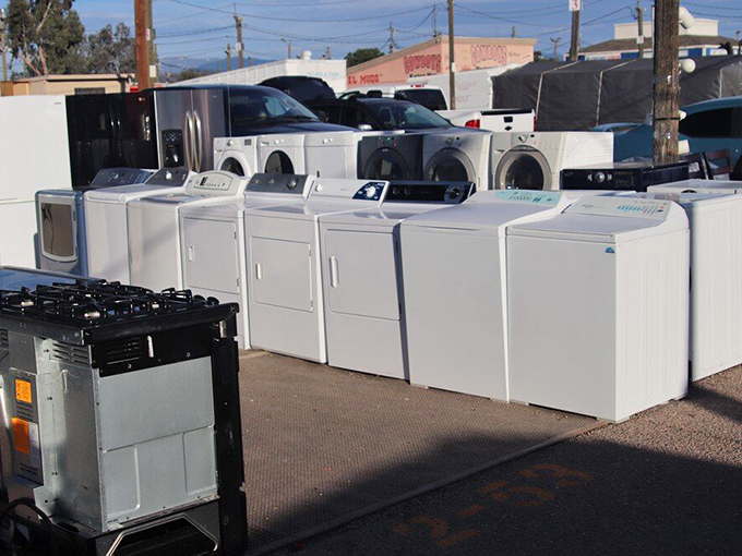 A field of pristine appliances awaits new homes. One person's upgrade is another's opportunity &ndash; the circle of household life in action.