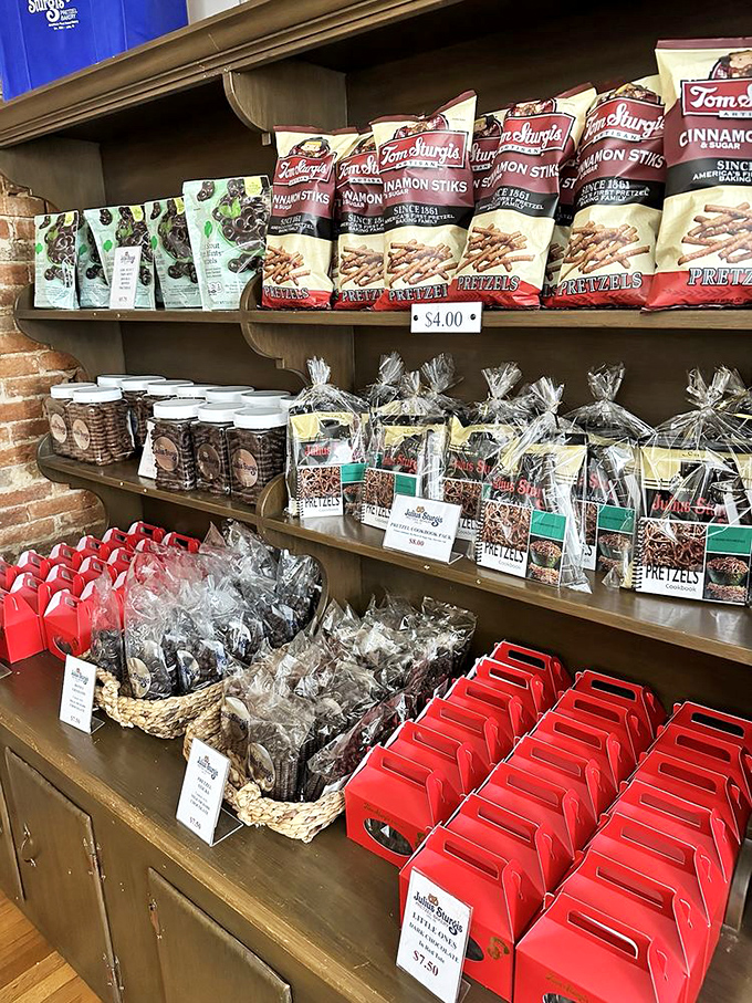 The gift shop wall&mdash;a shrine to carbohydrate devotion where pretzel varieties multiply like rabbits with ambition and flavor profiles to match.