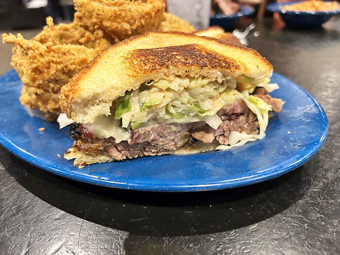 A sandwich built for serious eaters. Layers of smoked meat, slaw, and melted cheese between perfectly toasted bread&mdash;fork-optional but highly recommended.