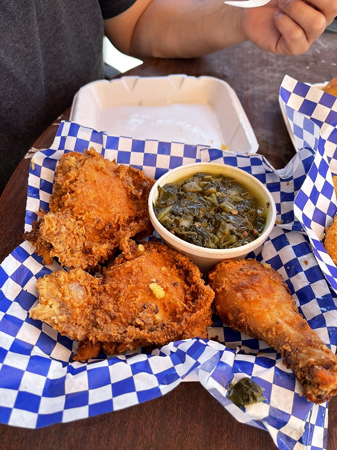 This blue-checkered basket of fried chicken with collard greens is the kind of meal that makes you close your eyes with each bite to fully appreciate the flavor.