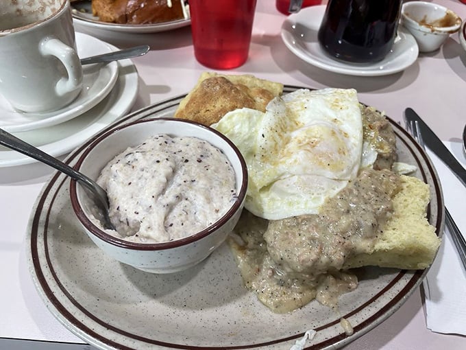 Biscuits swimming in creamy gravy alongside perfectly fried eggs—a plate that whispers "go back to bed after this" with every bite.