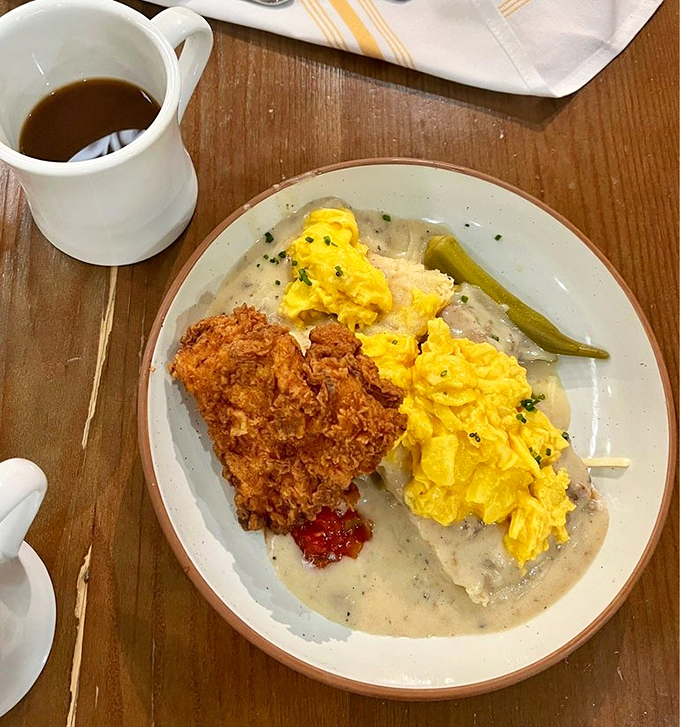 Biscuits and gravy crowned with fried chicken – the breakfast trifecta that makes cardiologists nervous and customers happy.