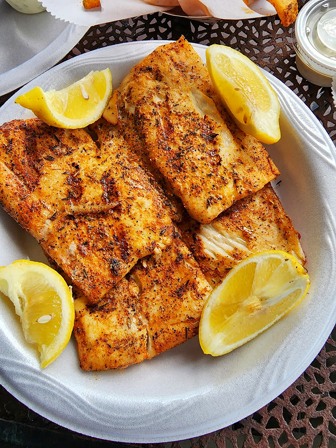 Blackened fish that proves sometimes the simplest preparation lets quality seafood shine. The char marks are basically flavor autographs.