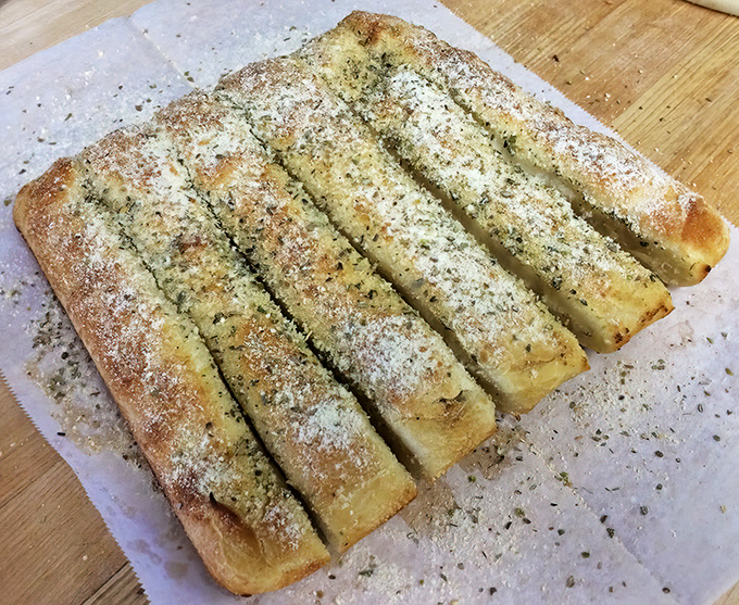 Garlic breadsticks: the unsung heroes of any pizza feast. Dusted with parmesan and herbs, they're the perfect opening act before the main event.