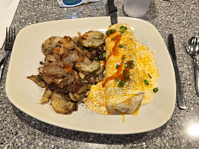 Another angle on breakfast perfection &ndash; golden potatoes beside an omelet that's been given the royal cheese treatment.