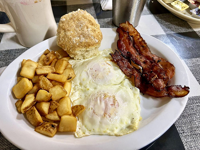The breakfast trinity &ndash; eggs, potatoes, and bacon &ndash; with a biscuit so fluffy it might float away if not for the gravitational pull of hunger.