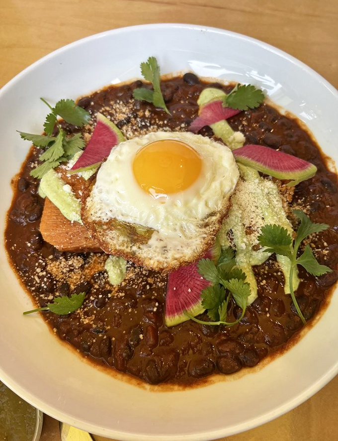 A breakfast tamale topped with a sunny-side egg is what happens when cultures collide in the most delicious way possible.