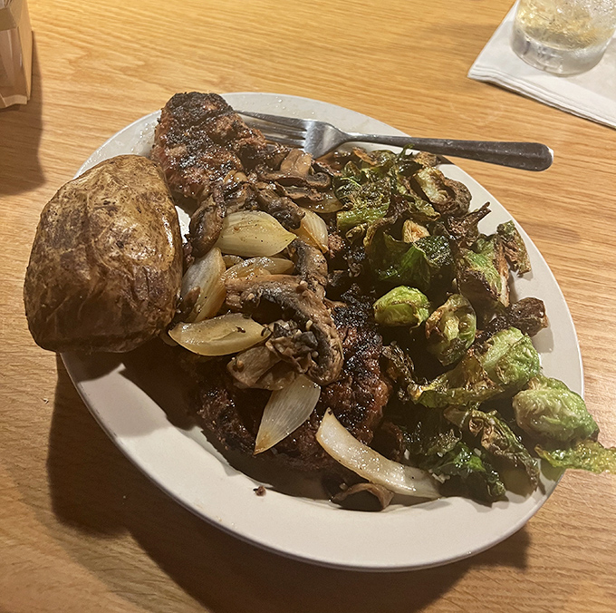 A plate where the steak shares the spotlight with caramelized Brussels sprouts and mushrooms&mdash;proof that vegetables can be more than just obligation eating.
