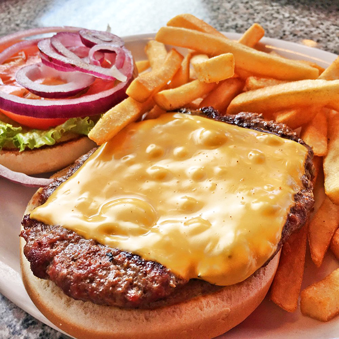 A proper diner burger with cheese melted just right, ready to remind you why sometimes the classics simply can't be improved upon.