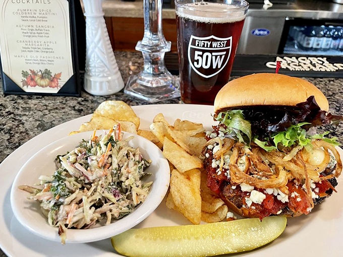 This burger isn't just food; it's architecture. The crispy onions and side of slaw create a perfect harmony of textures.