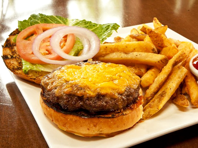 A burger that doesn't need fancy toppings to impress—just perfectly seasoned beef, melted cheese, and fries that deserve their own fan club.