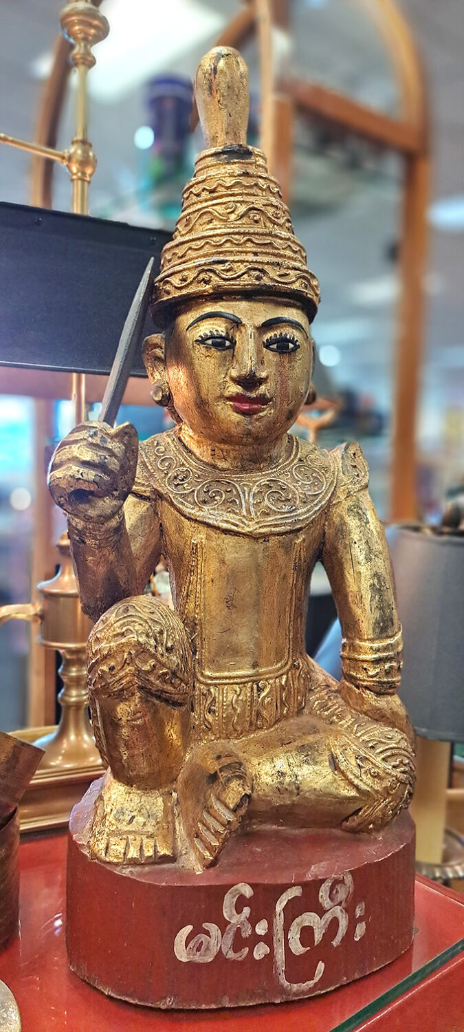 This golden Burmese statue brings exotic mystique to any room craving international flair and conversation.
