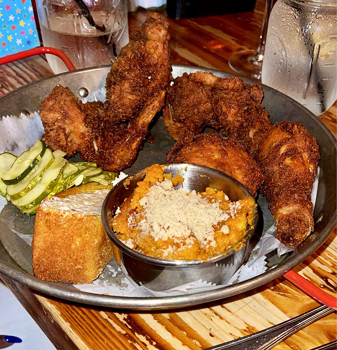 This isn't just fried chicken&mdash;it's edible artwork with a PhD in comfort food. That side of sweet potato something has me ready to book a table.