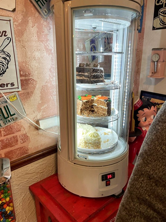 The rotating cake display&mdash;a glass tower of temptation that makes willpower crumble faster than the crust on that carrot cake.