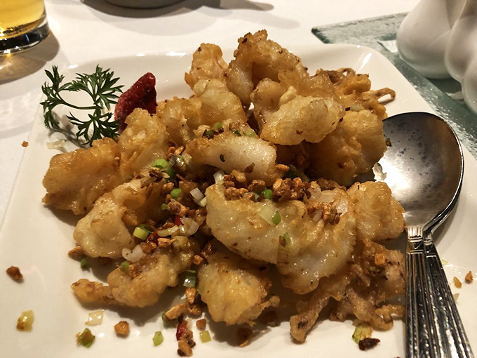 Salt and pepper calamari that crackles with each bite, topped with a confetti of chilis and scallions. Squid has never been so dressed up for dinner.