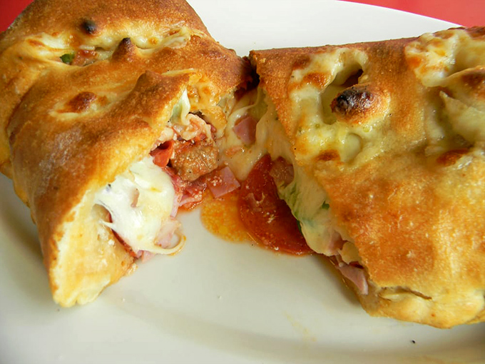 This golden calzone bursts with melted cheese and savory fillings that make every bite feel like a warm hug.