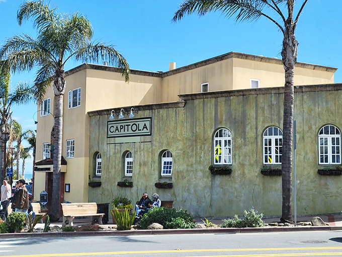The historic Capitola building stands as a sun-drenched landmark, watching over beachgoers as it has for generations.