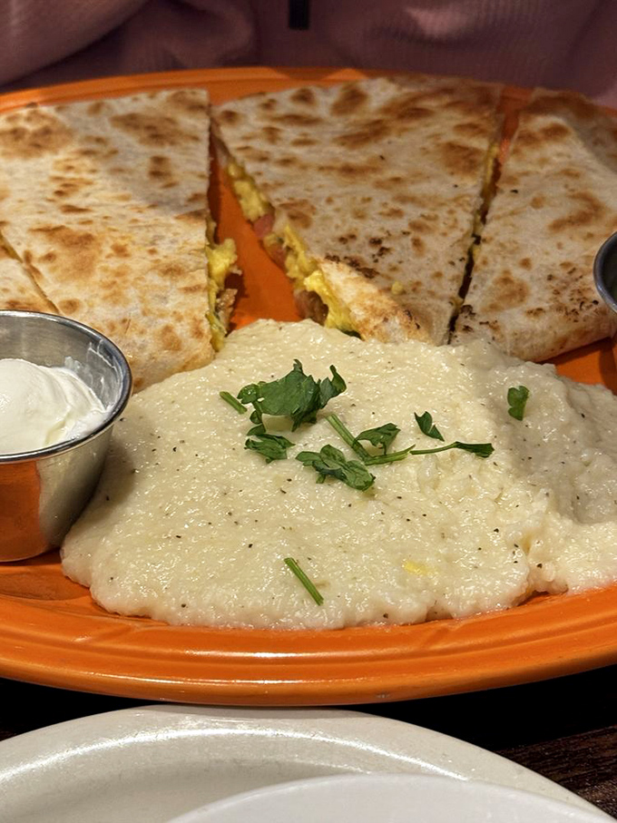 Cheesy quesadilla triangles guard a creamy moat of grits—proof that breakfast borders between countries should always remain deliciously open.