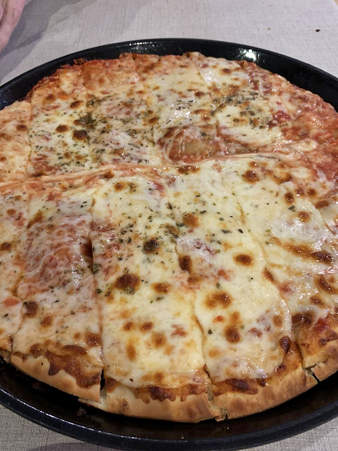 Another angle of pizza perfection&mdash;where the slightly charred cheese bubbles tell you everything you need to know about the high-temperature magic happening in that kitchen.