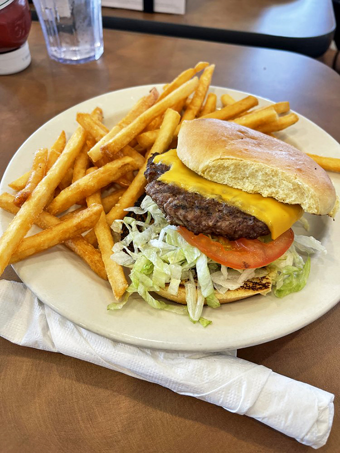 Behold the cheeseburger in its natural habitat&mdash;surrounded by golden fries and waiting patiently to fulfill its delicious destiny.
